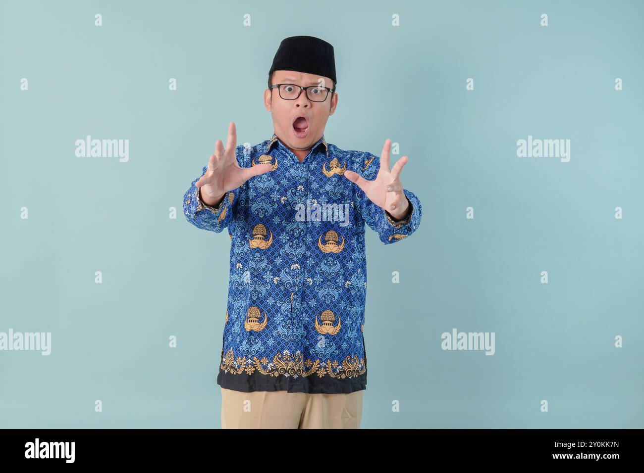 Stressed Indonesian government worker man wearing blue batik uniform ...