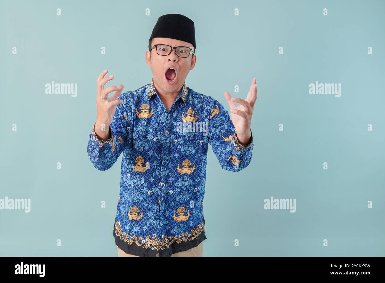 Stressed Indonesian government worker man wearing blue batik uniform ...