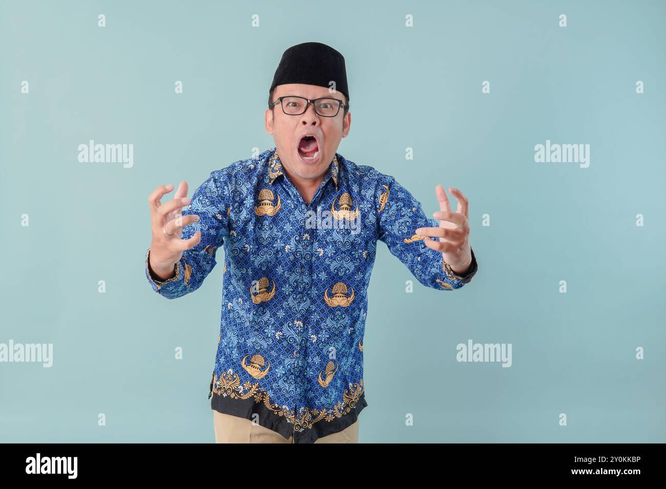 Stressful Indonesian government worker man wearing blue batik uniform ...