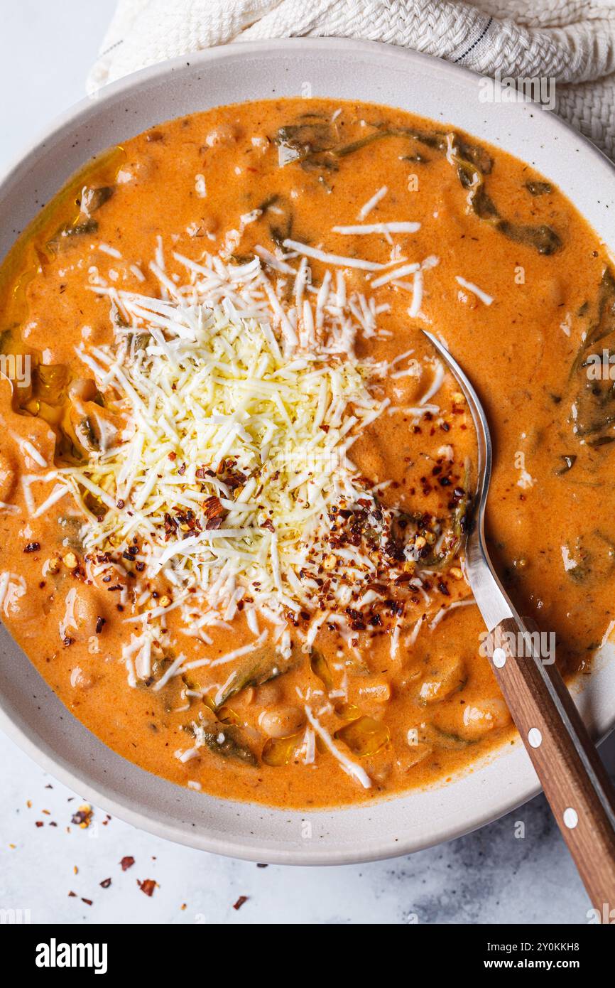 Creamy tomato white bean stew with spinach and cheese, top view Stock ...