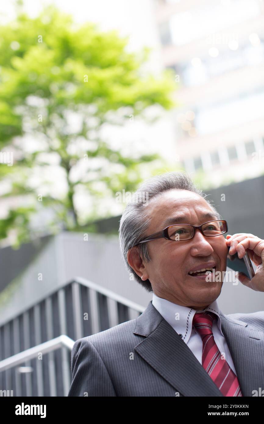 Mature smart businessman calling hi-res stock photography and images ...