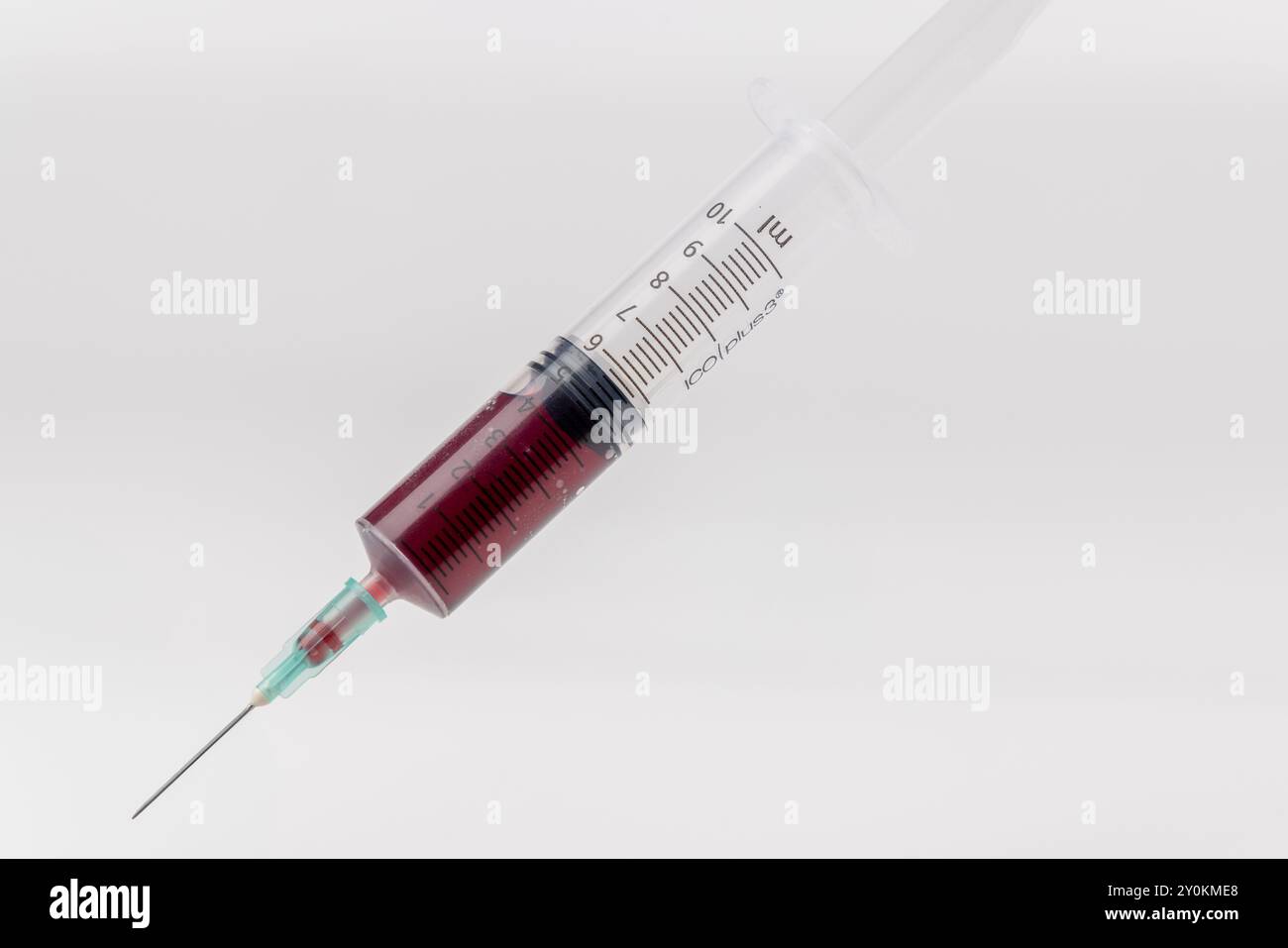 Close-up view of a syringe containing blood, tilted and centrally ...