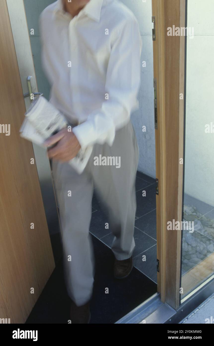 Man entering into a room Stock Photo - Alamy