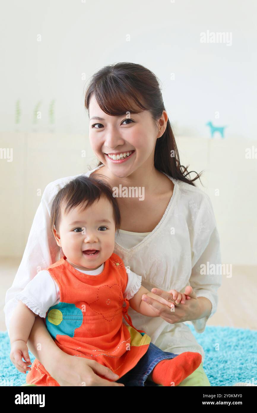 Mother hugging her baby Stock Photo - Alamy