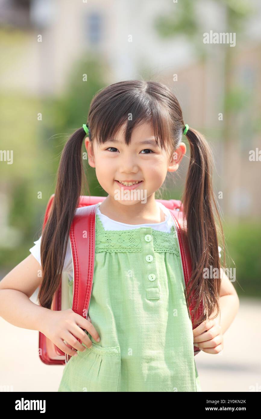 Girl carrying satchel on her back Stock Photo - Alamy