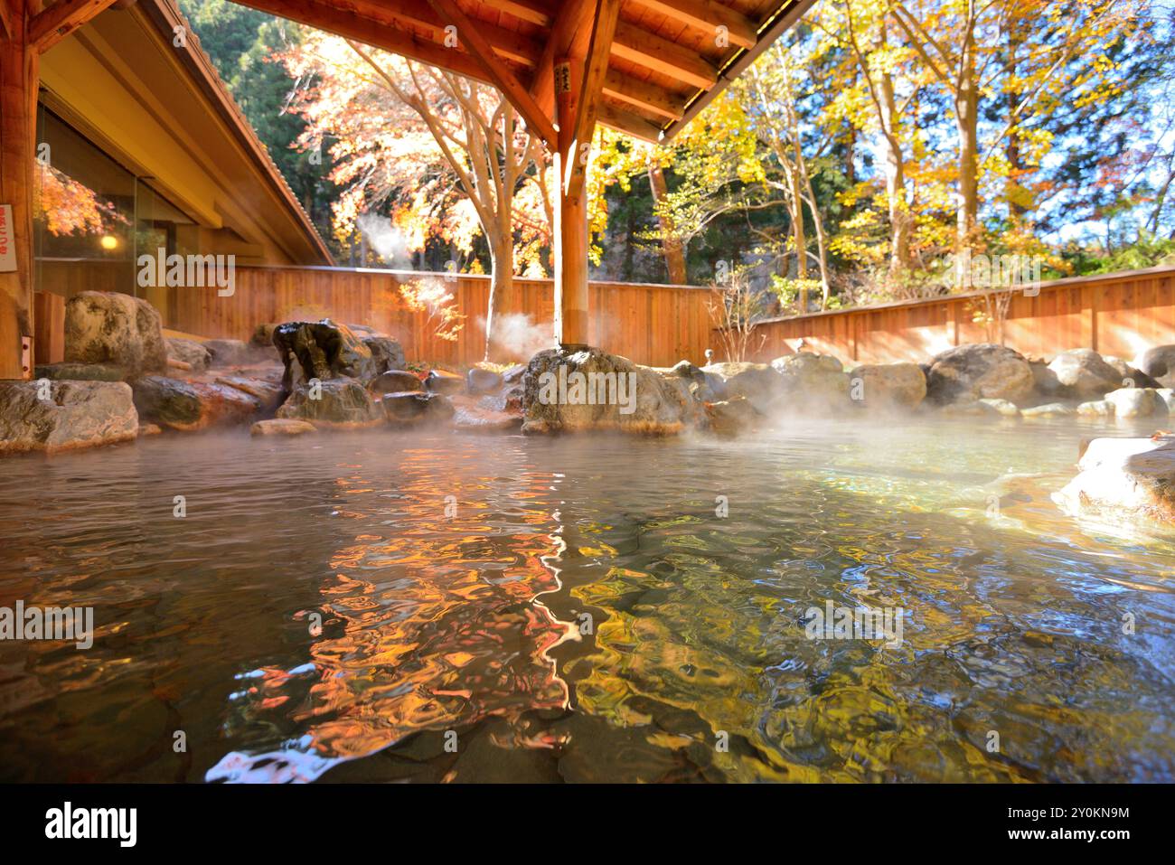Open air hot spring with autumn foliage Stock Photo - Alamy