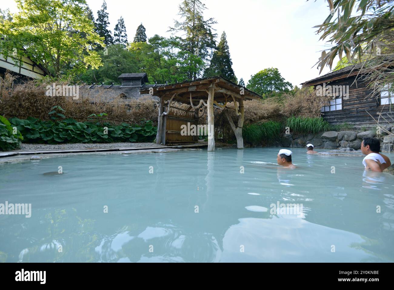 Open air bath of opaque hot water Stock Photo - Alamy