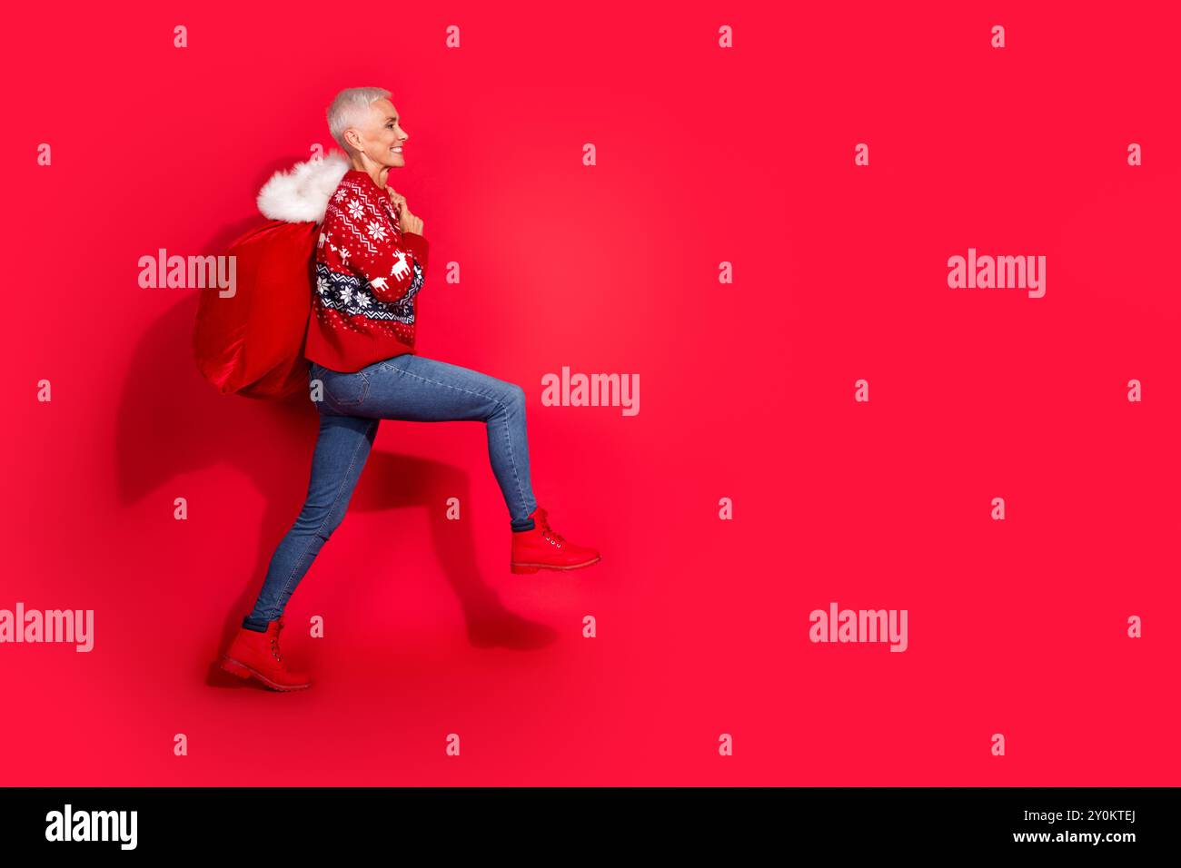 Full body photo of attractive senior woman walking carry gift sack ...