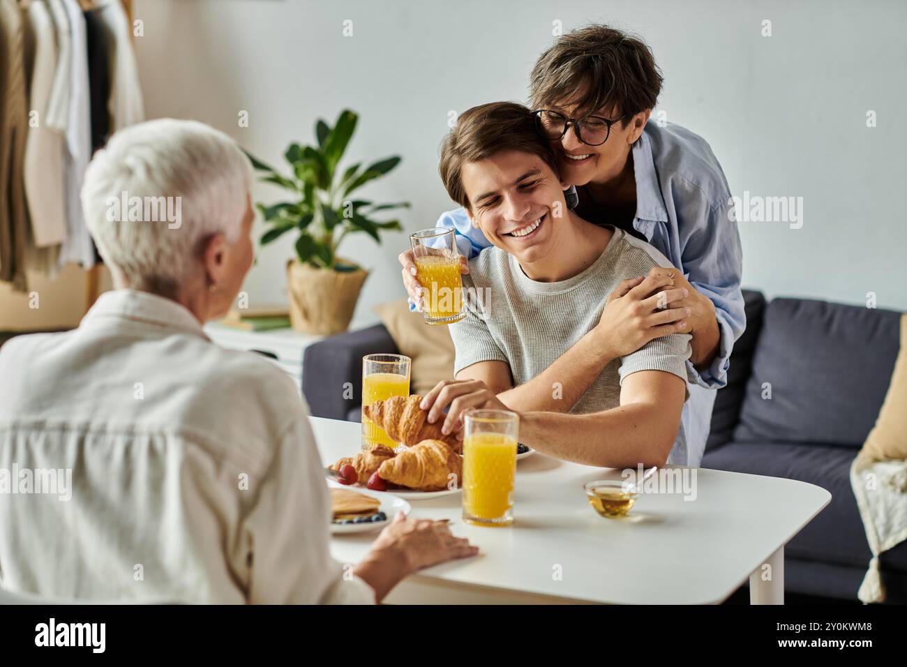 A loving family enjoys breakfast, sharing laughter and joy in a warm ...