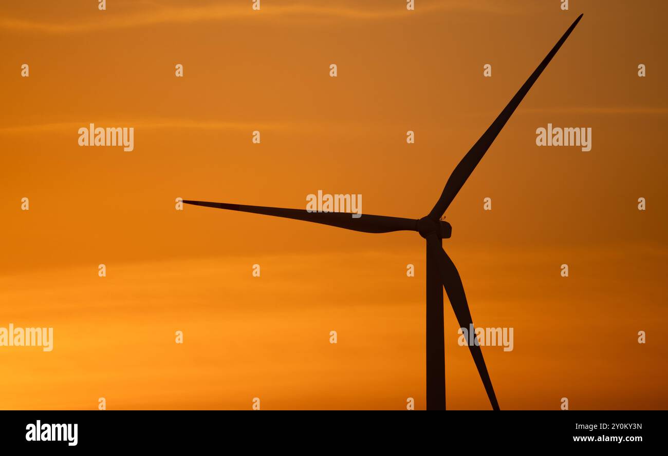Wind turbine silhouette against sunset sky. Wind power. Sustainable ...