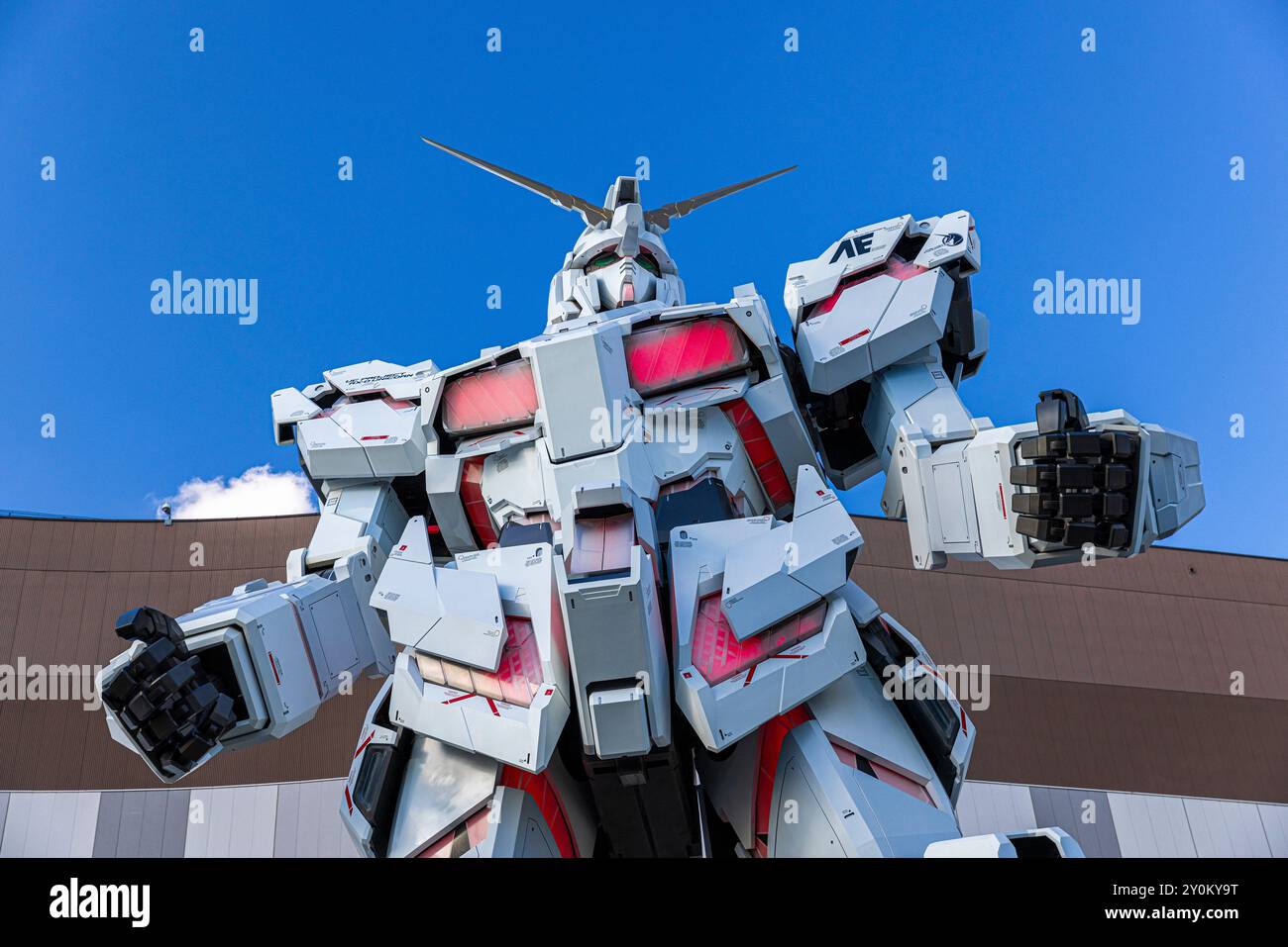 Giant gundam robot standing tall against blue sky in odaiba, tokyo ...