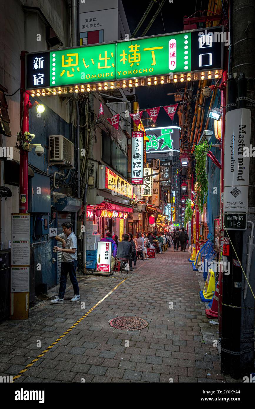 omoide yokocho alley with illuminated signs at night in shinjuku, tokyo ...