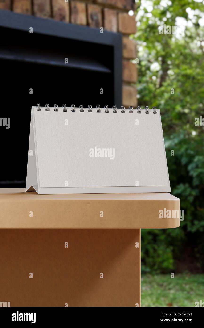 A calendar is standing upright on a table with a blank page Stock Photo ...