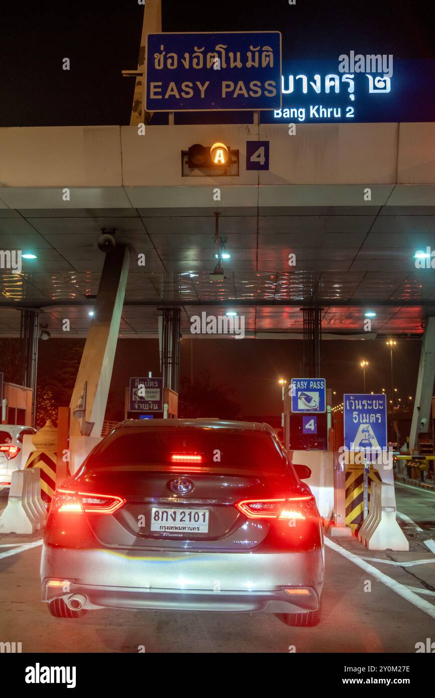 BANGKOK, THAILAND, APR 21 2024, Cars standing at gate motorway entrance ...