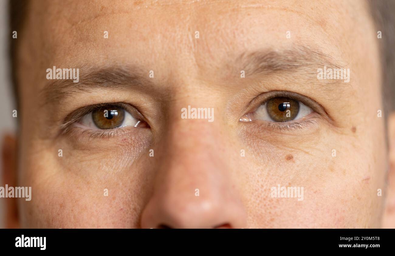 Close-up of man's eyes, focusing on facial expression and eye detail ...