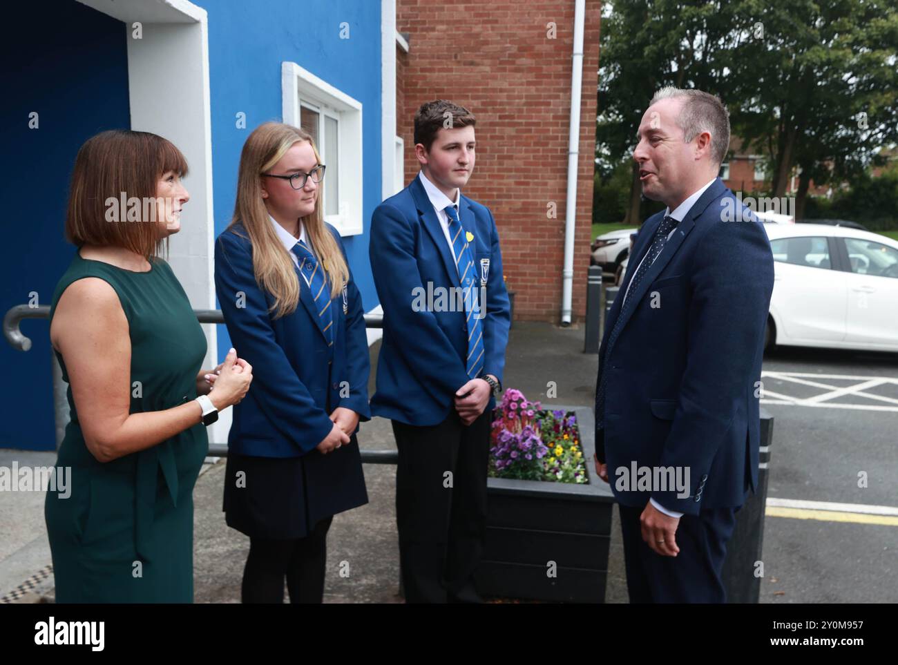 Principal Maria Flynn, Head Girl Abigail Morris and Head Boy Ciaran McCusker greet Education ...