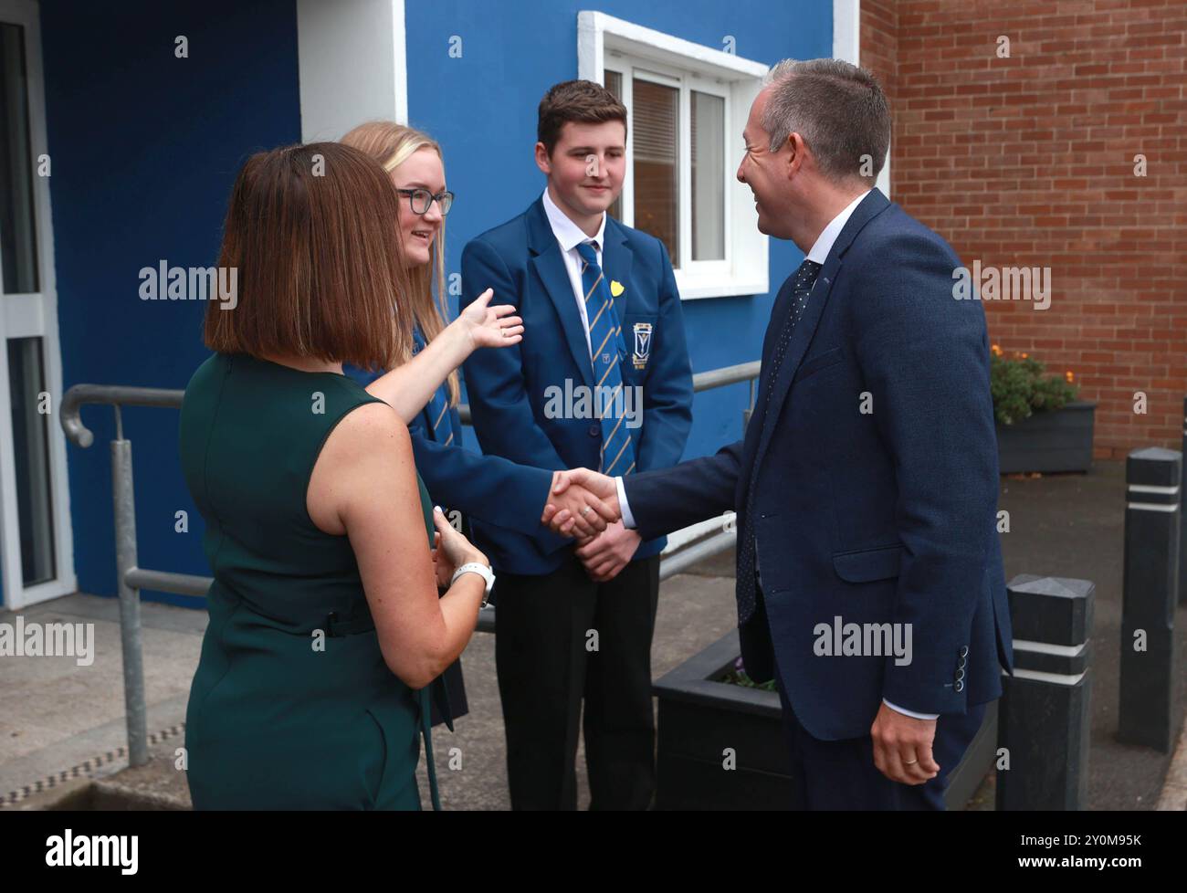 Principal Maria Flynn, Head Girl Abigail Morris and Head Boy Ciaran McCusker greet Education ...