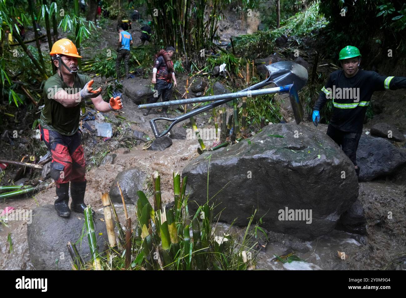 A rescuer throws equipment as they move to safer grounds during a halt ...