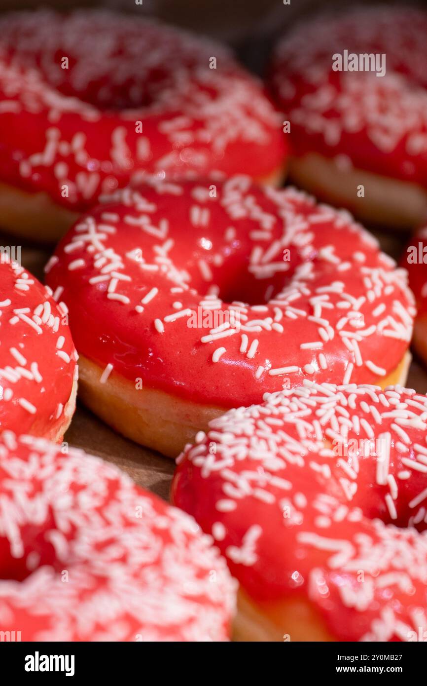 a close up of delicious looking pink donuts Stock Photo - Alamy