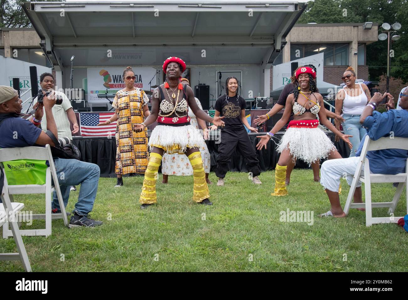 2 dancers from the Fusha Dance Company dance with audience members ...