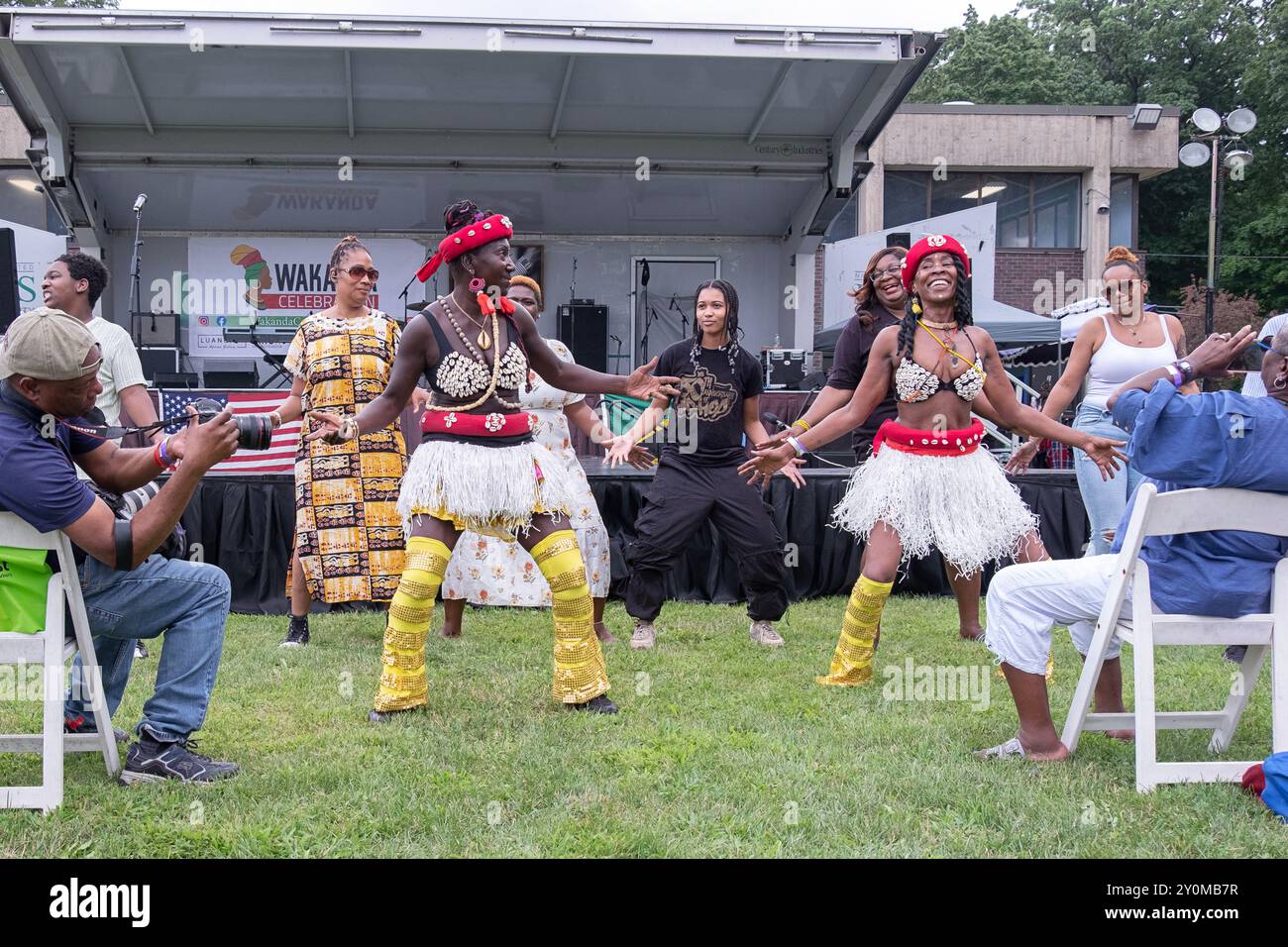2 dancers from the Fusha Dance Company dance with audience members ...
