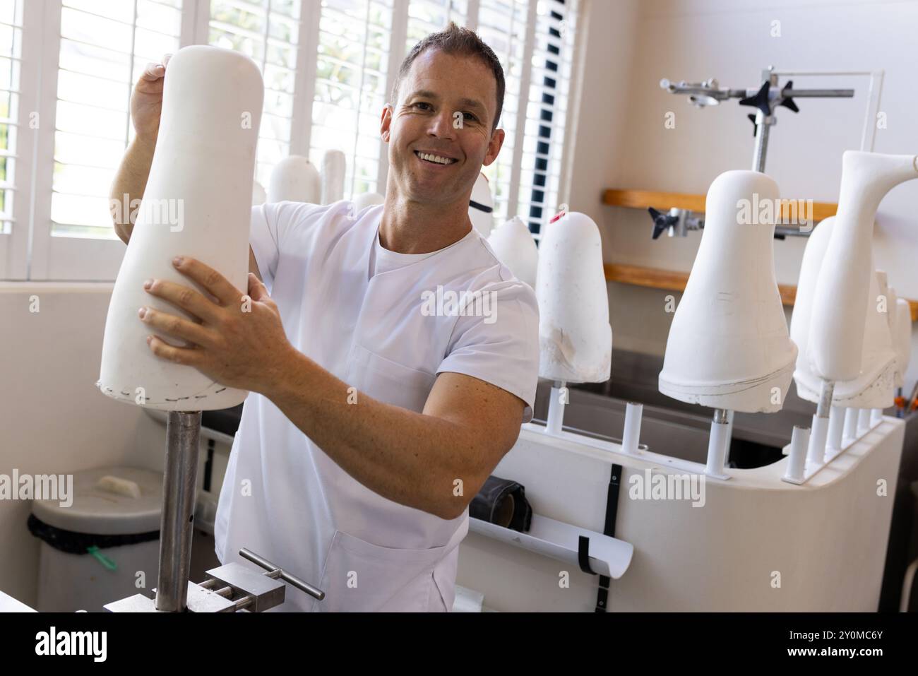 Working in prosthetic lab, man crafting prosthetic limbs with precision ...