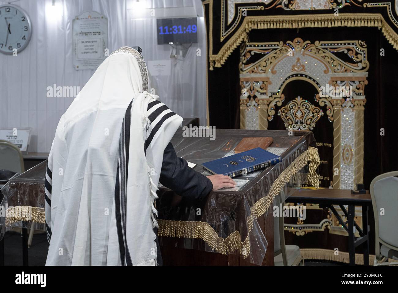 In a synagogue in Monsey, NY, an orthodox Jewish man leads the ...