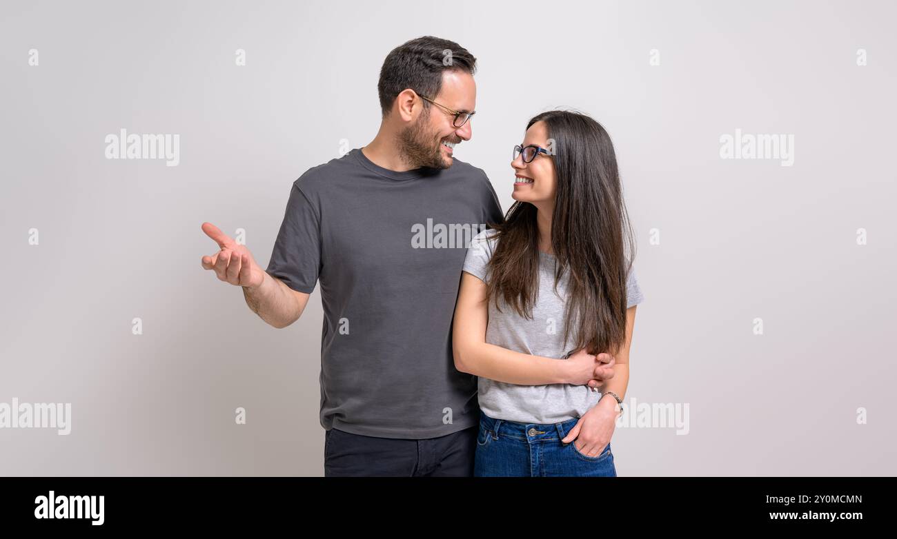 Loving couple smiling and holding hands while looking at each other on ...
