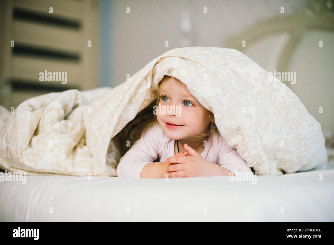 girl child waking up in the morning having fun and playing in bed Stock ...
