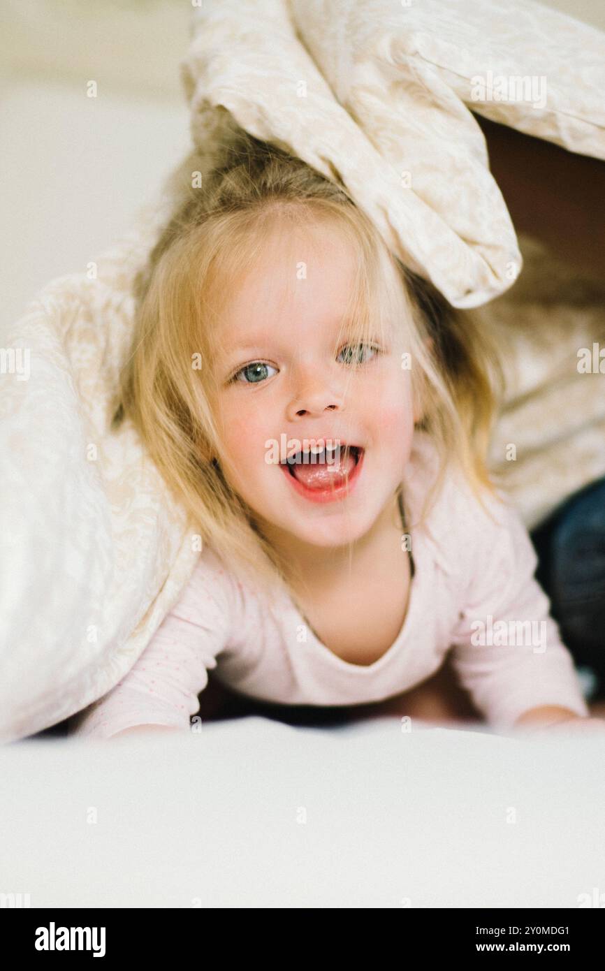 girl child waking up in the morning having fun and playing in bed Stock ...