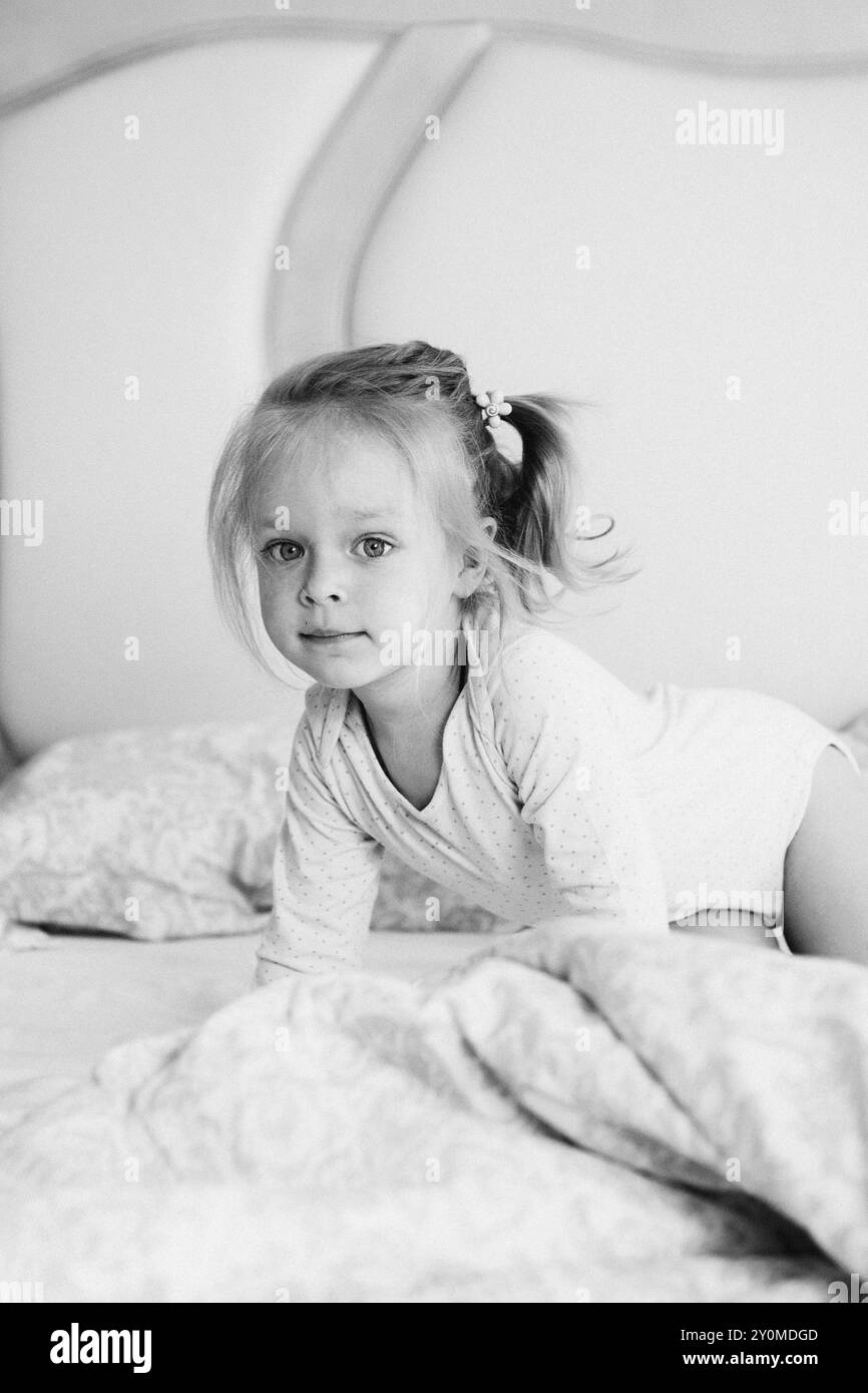 girl child waking up in the morning having fun and playing in bed Stock ...