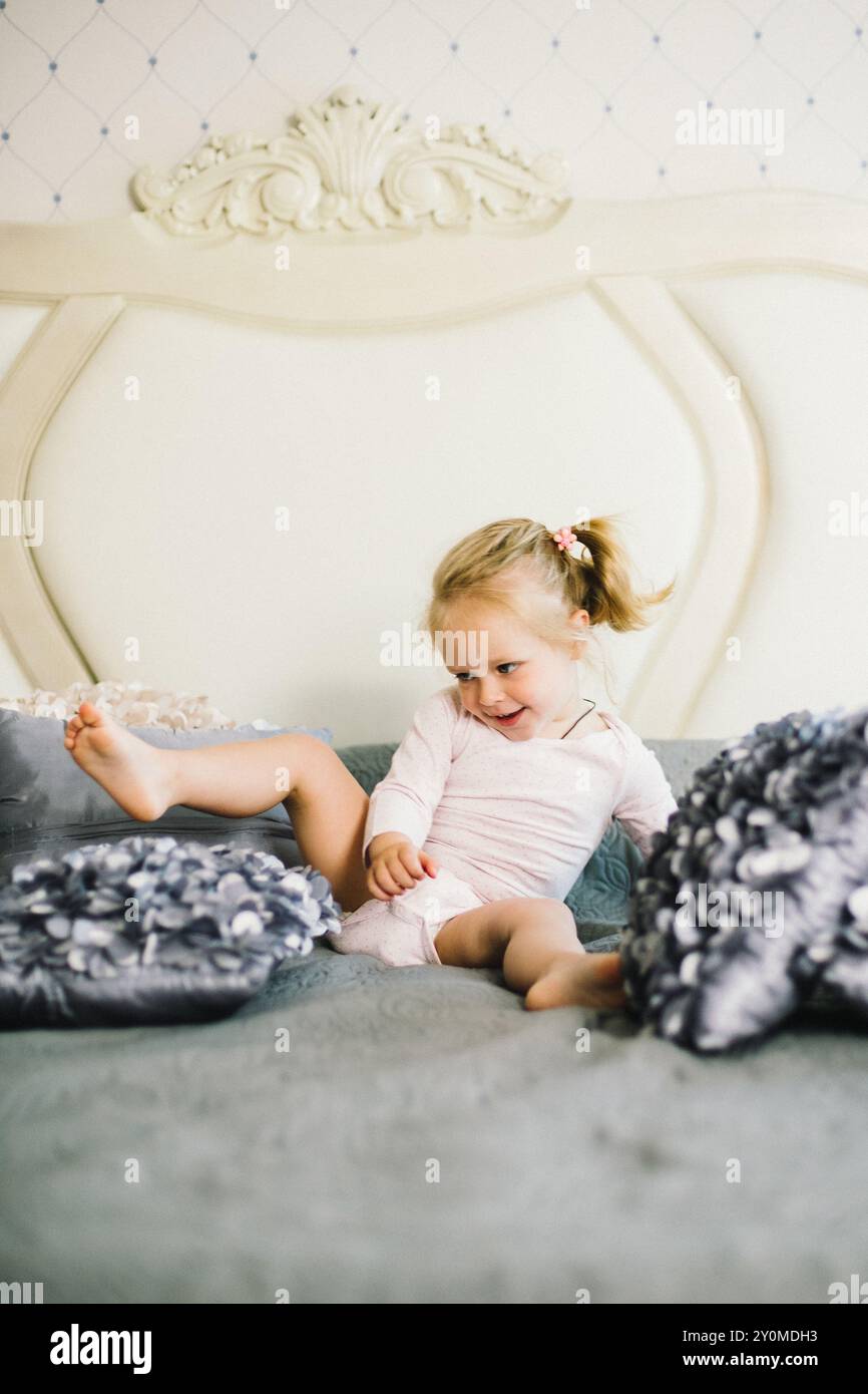 girl child waking up in the morning having fun and playing in bed Stock ...