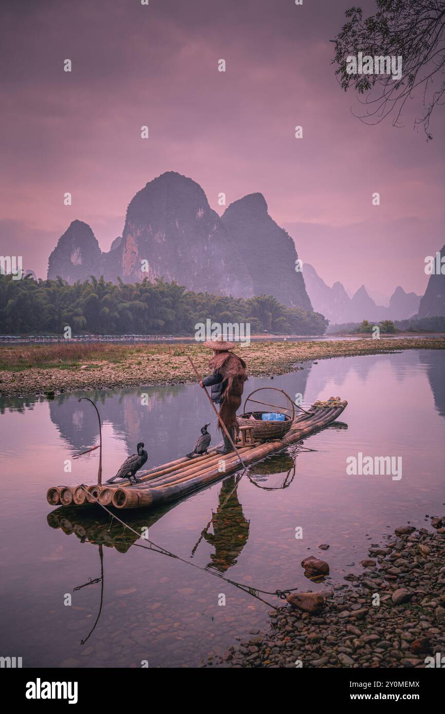 Cormorant fisherman and his bird on the Li River in Yangshuo, Guangxi ...
