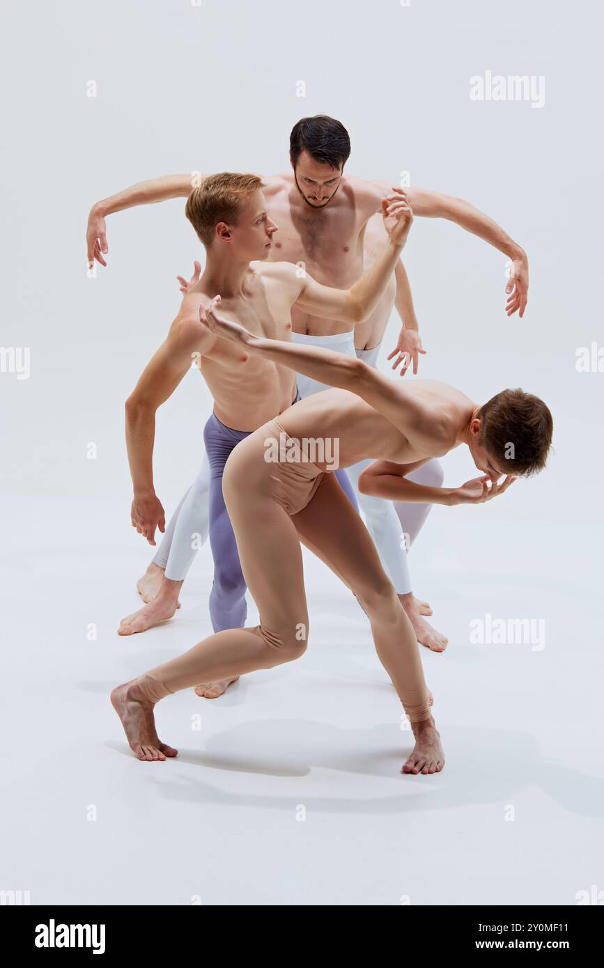 Dancers bend and reach, exercising their bodies to create art through synchronized, expressive ...