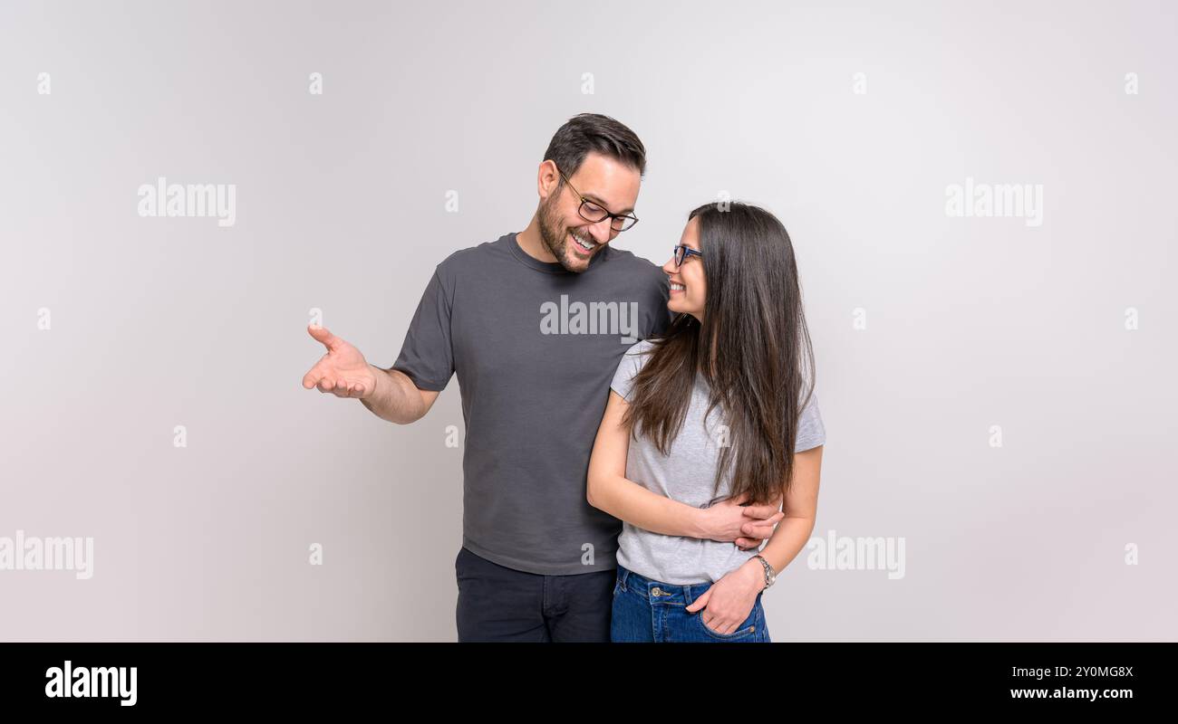 Happy romantic boyfriend with arm around girlfriend flirting with her ...