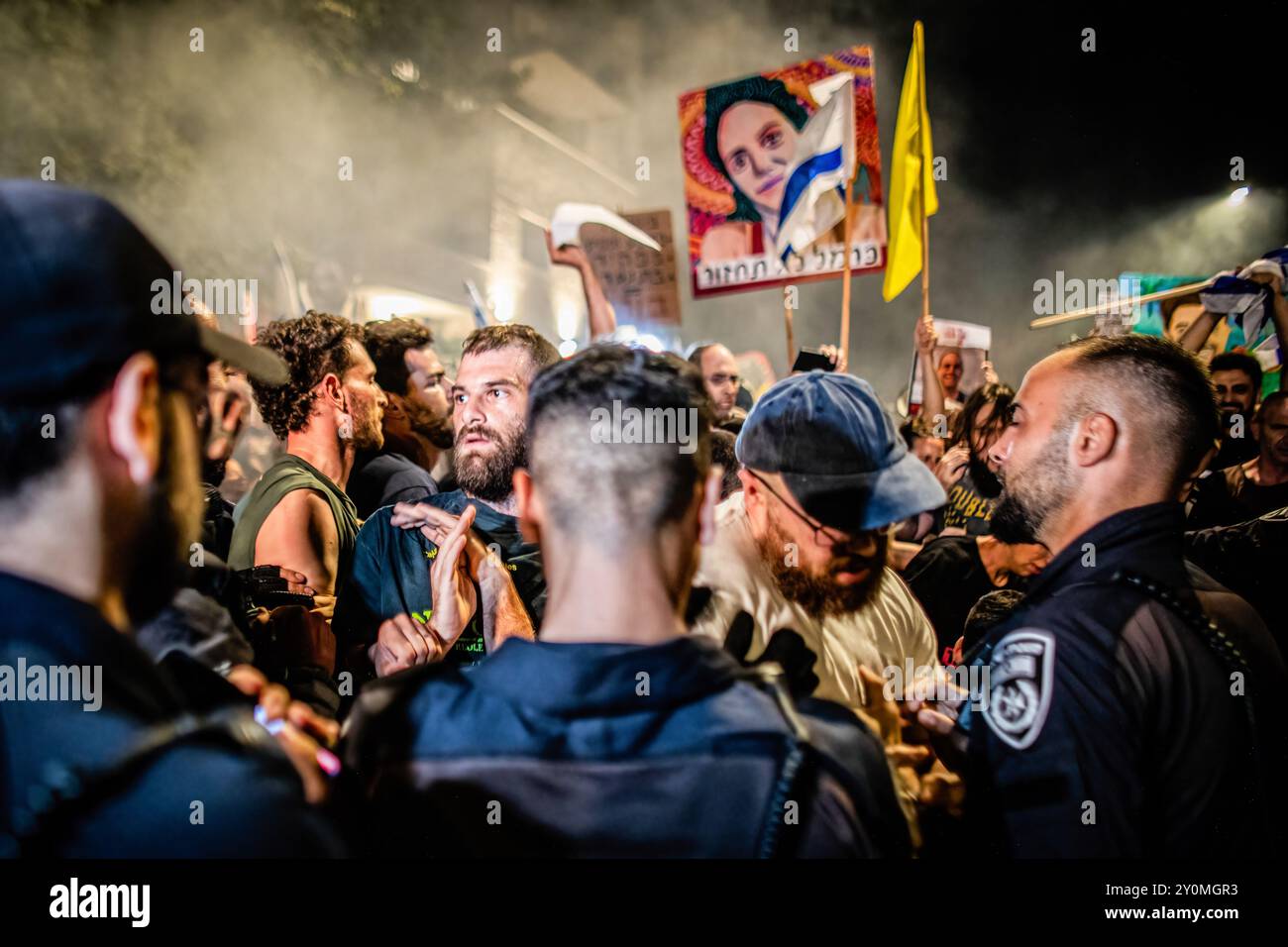 Protesters are pushed back by Israeli police officers during a ...
