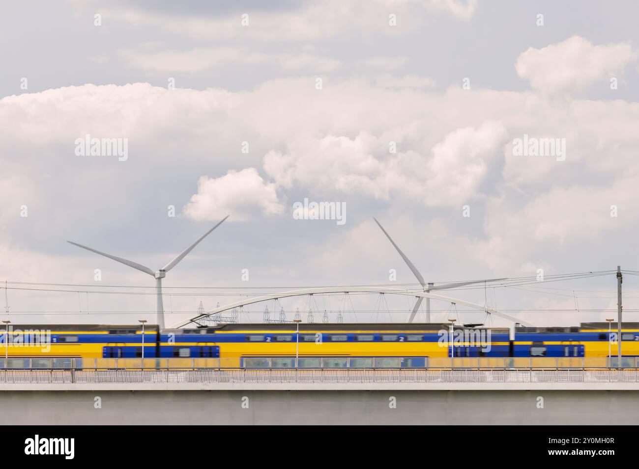 Dutch intercity train passing bridge over the Waal river in Nijmegen ...