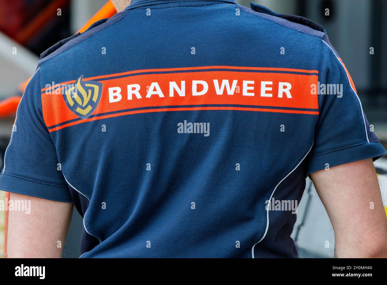 Close up of a fire fighter uniform with the Dutch text for "fire ...