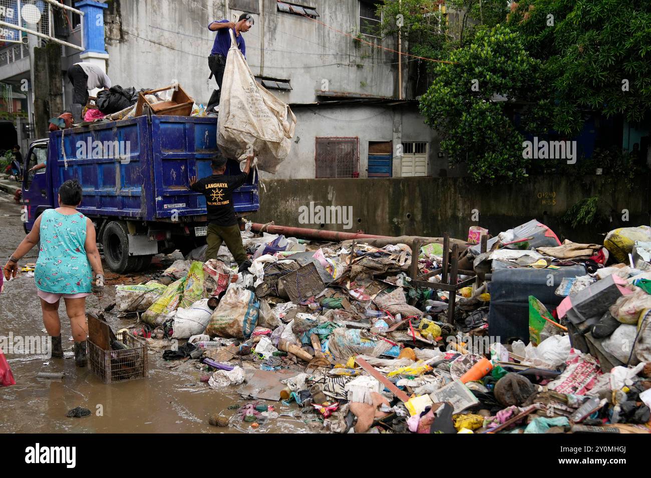Workers collect garbage after floods caused by Tropical Storm Yagi ...
