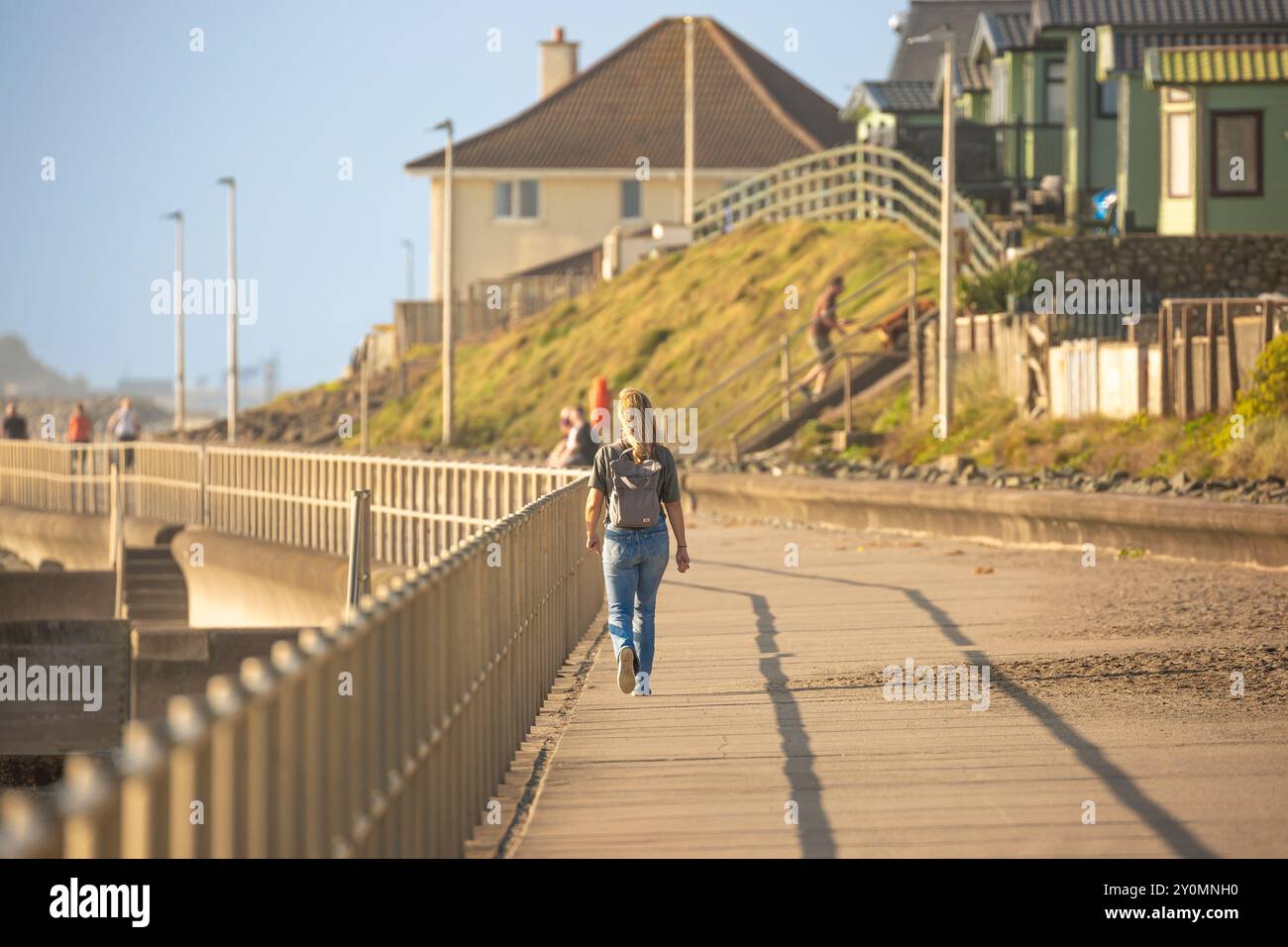 Holiday makers on the promenade at Tywyn Beach, Wales Stock Photo - Alamy