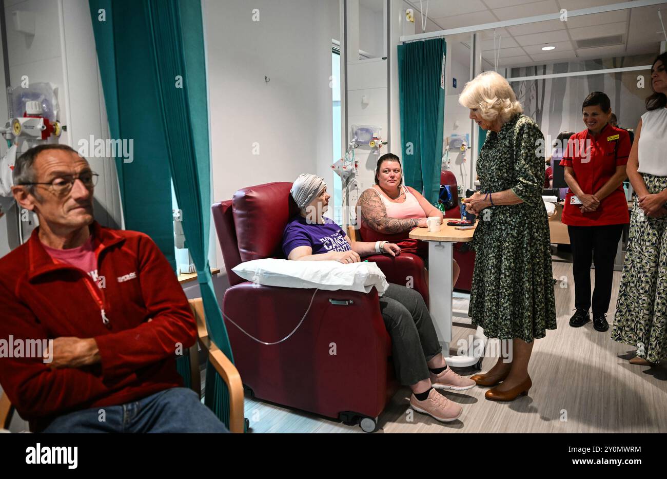 Queen Camilla speaks with cancer patient Jill Hitchman while she ...