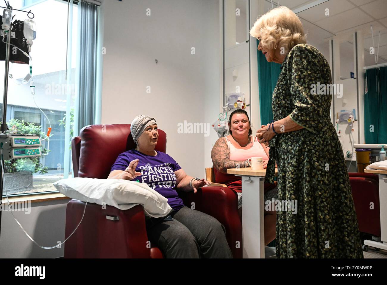 Queen Camilla speaks with cancer patient Jill Hitchman while she ...