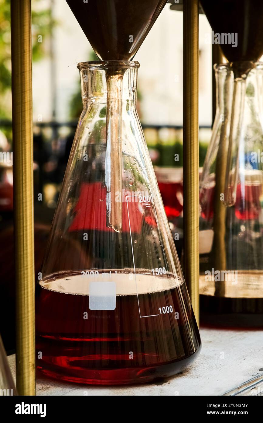 Artisanal outdoor coffee brewing setup featuring glass flasks and ...