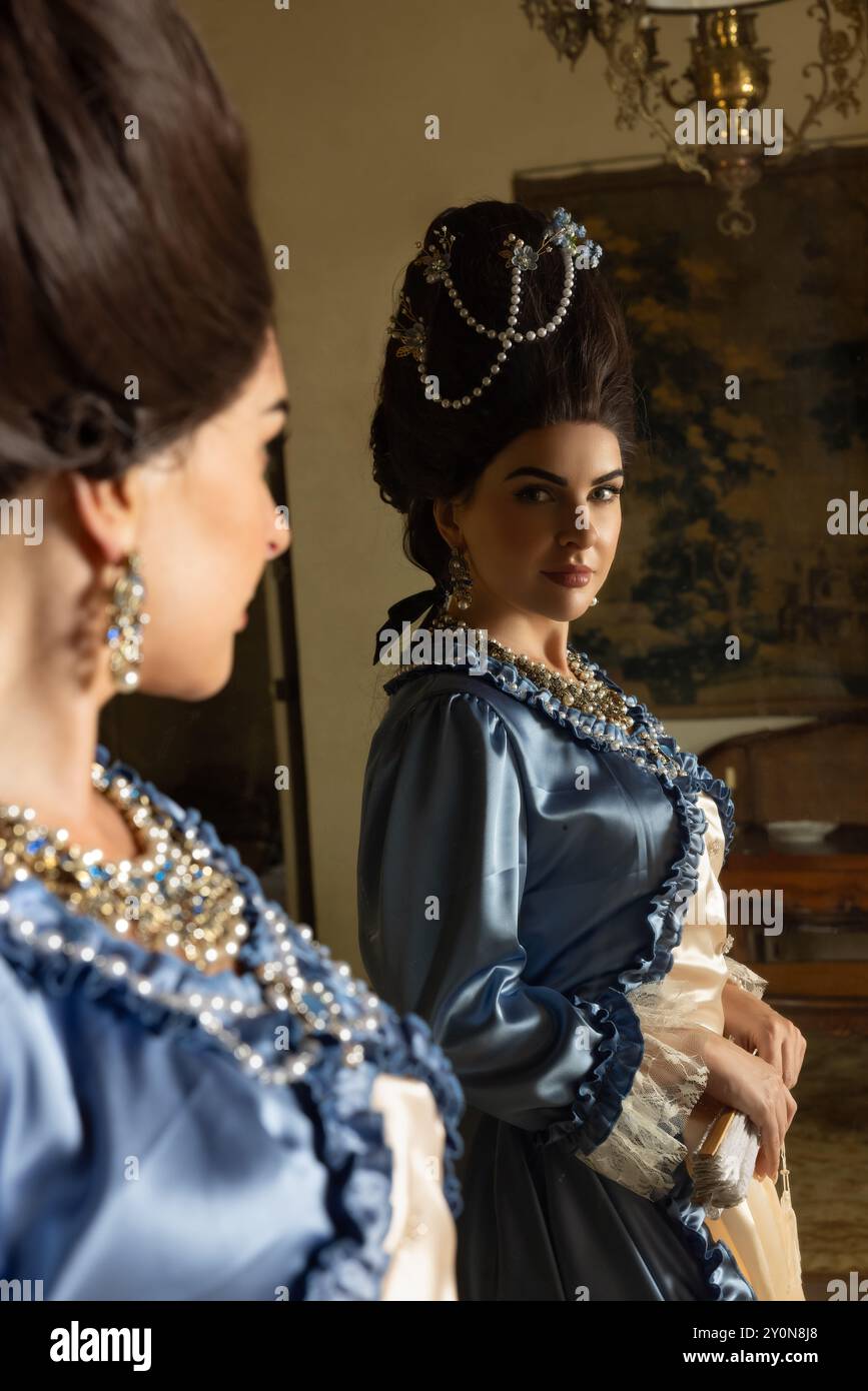 Beautiful young woman dressed in rococo queen Marie Antoinette style ...