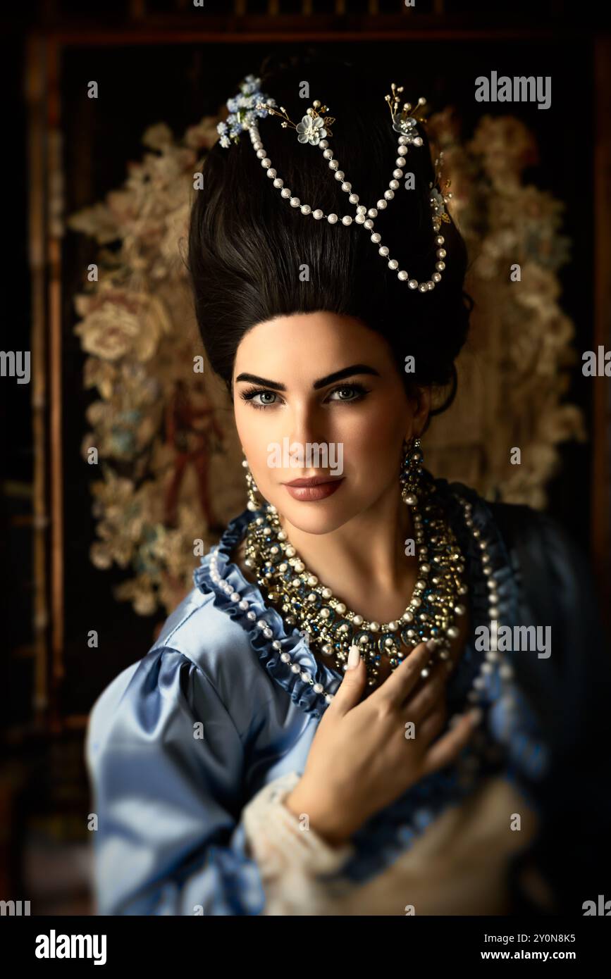 Beautiful young woman dressed in rococo queen Marie Antoinette style ...