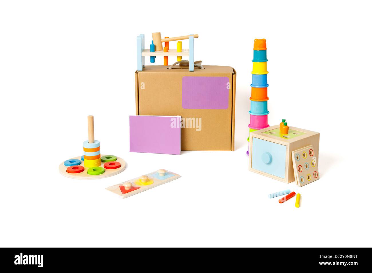 Wooden and plastic puzzle toy with colorful blocs next to the box ...