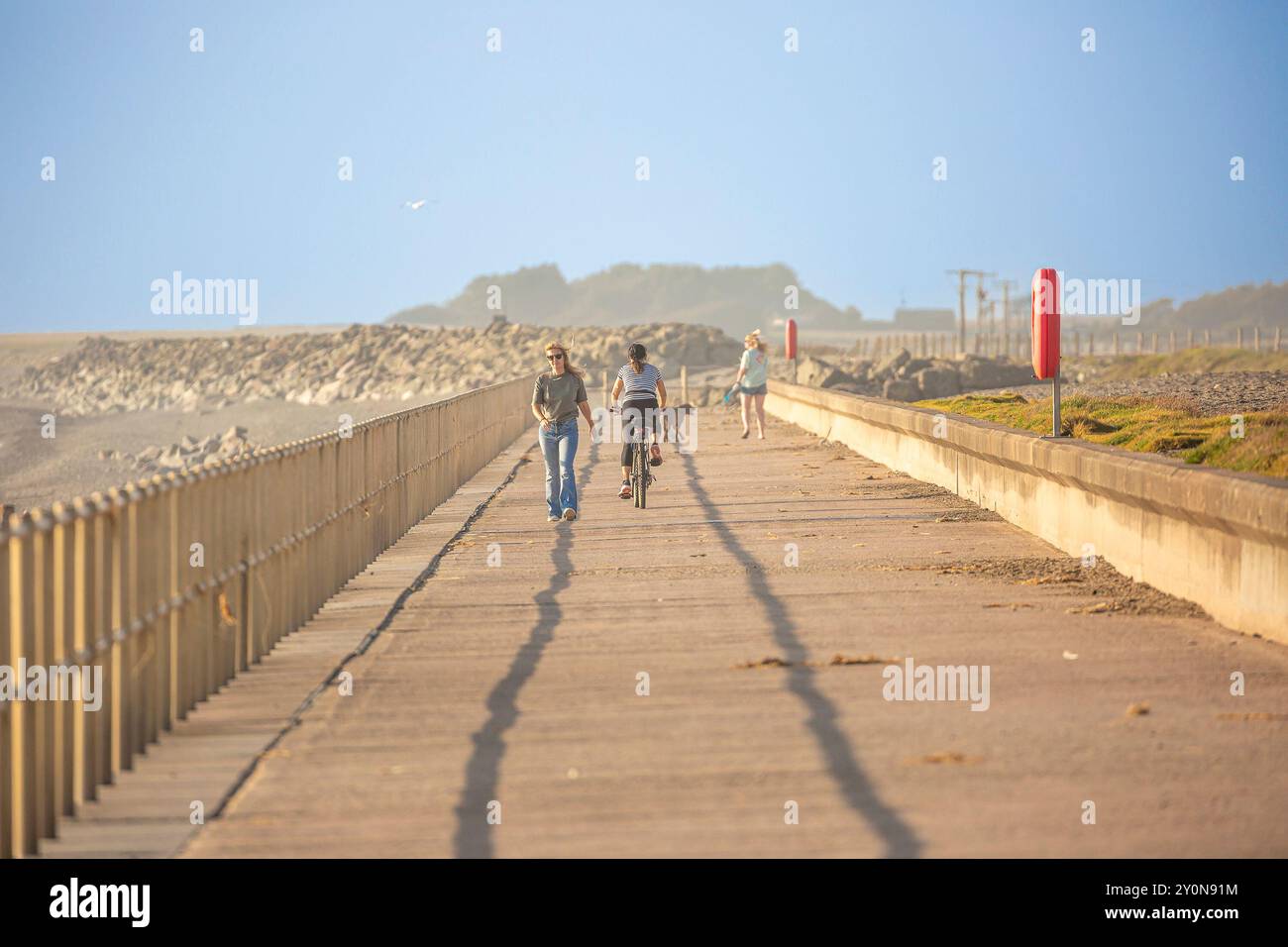 Holiday makers on the promenade at Tywyn Beach, Wales Stock Photo - Alamy