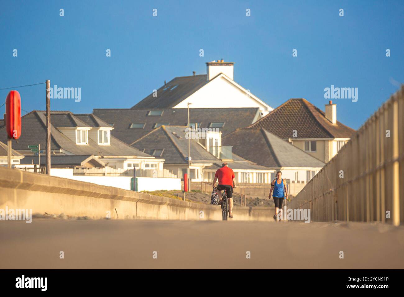 Holiday makers on the promenade at Tywyn Beach, Wales Stock Photo - Alamy