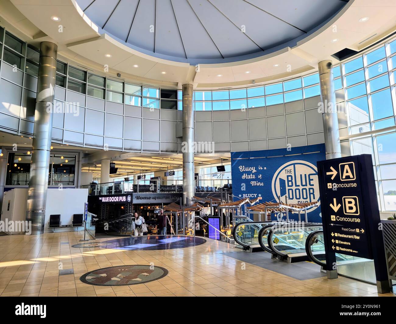 Modern Airport Terminal with Blue Door Pub and Escalators - Elevated ...