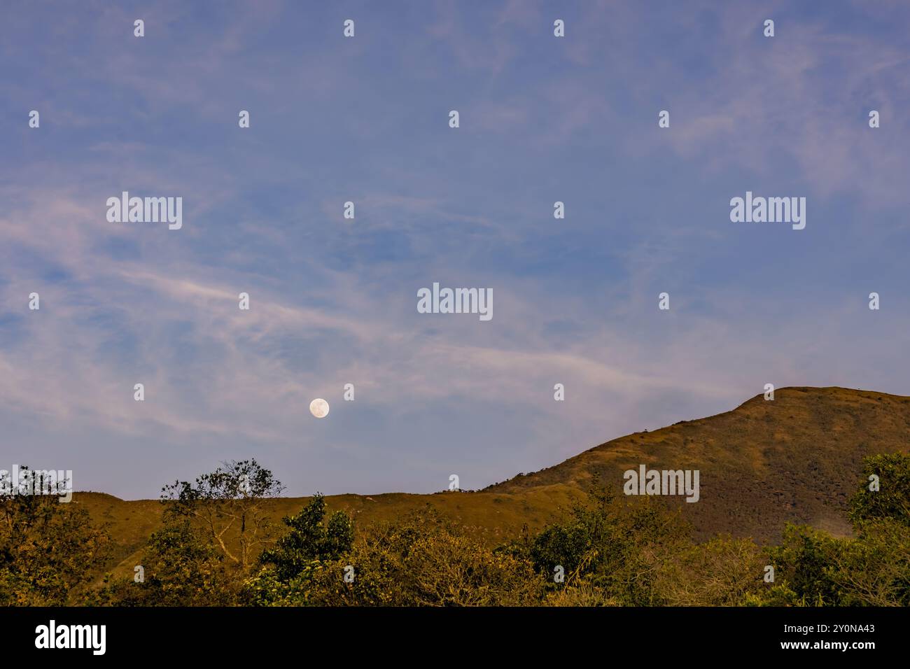 The almost full crescent moon rises over the Iguaque mountain, in the ...